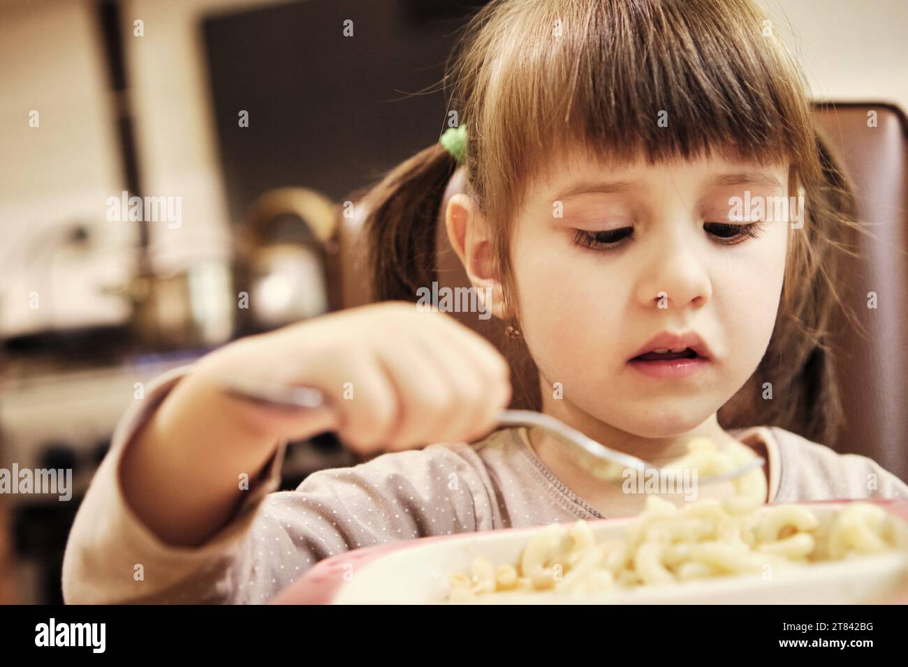 Child eating shaped pasta Stock Photo - Alamy