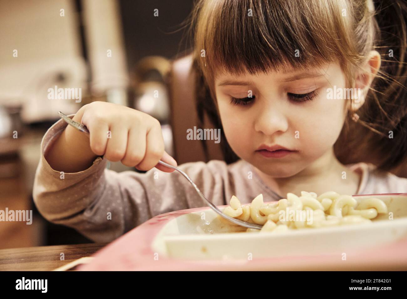 Child eating shaped pasta Stock Photo - Alamy
