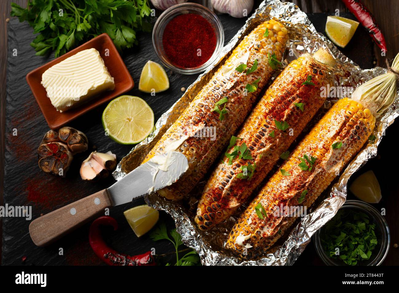 Grilled Sweetcorn with smoked paprika lime and butter in tin foil on ...