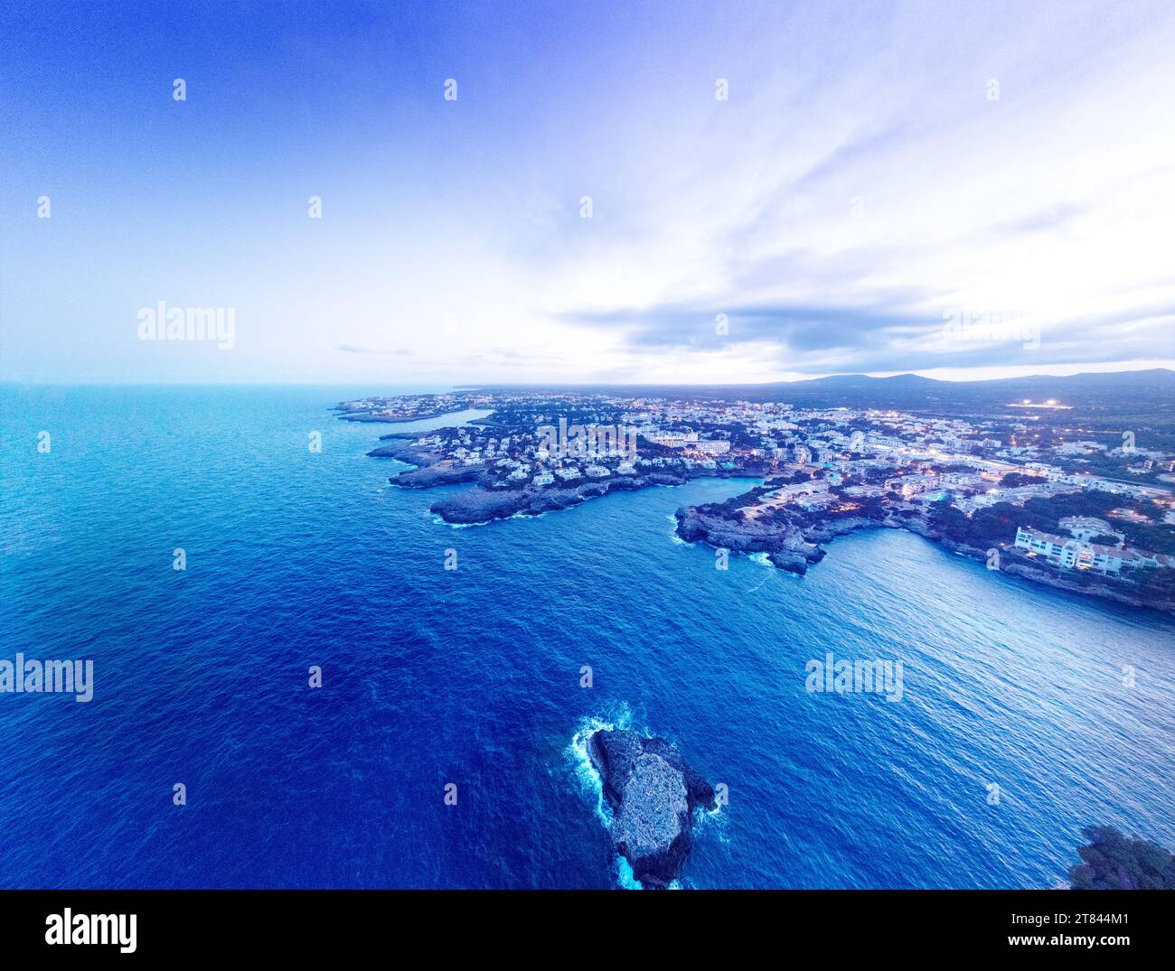 Aerial view of Cala Esmeralda at night , above the sea looking back at ...