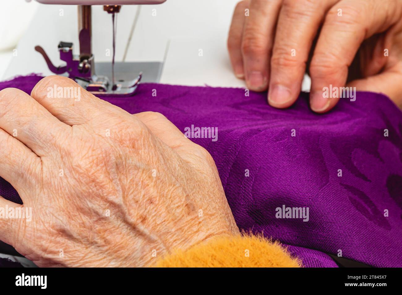 Adult woman sewing purple hi-res stock photography and images - Alamy