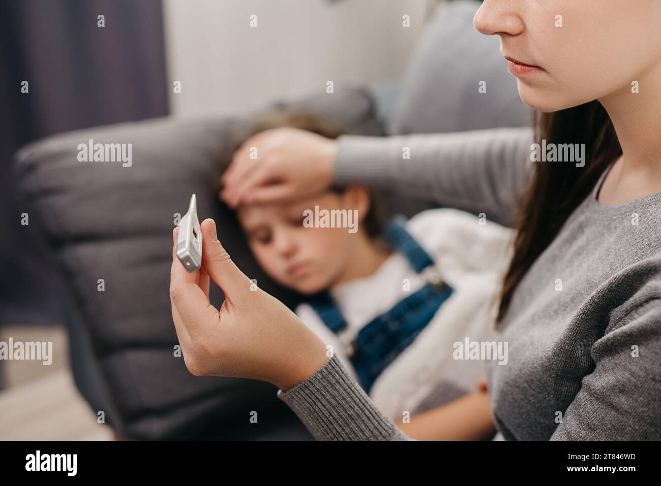 Selective focus of concerned young mother checking high body ...