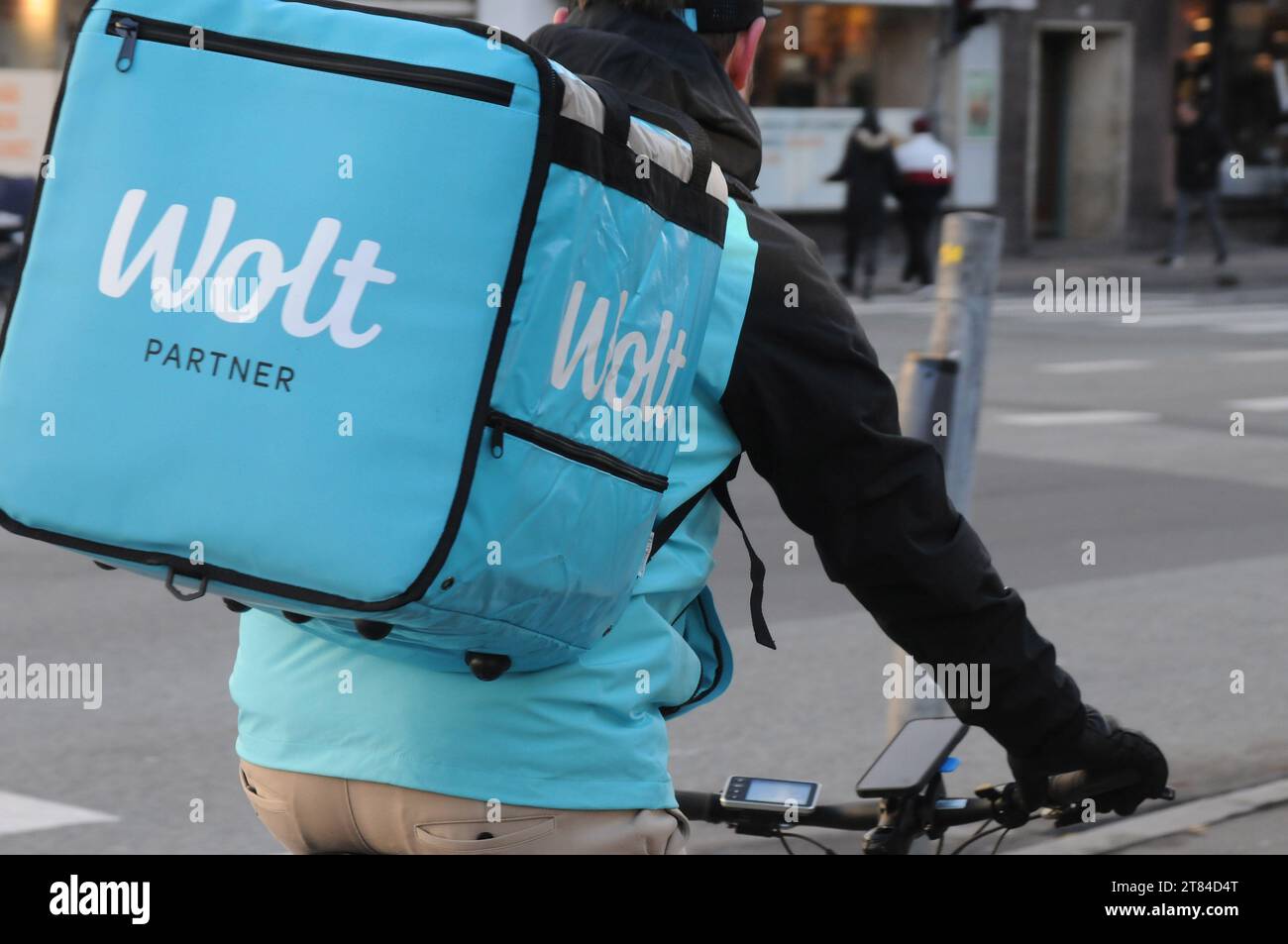 Copenhagen, Denmark /18 November 2023/. Wolt partner food delivery bikers and store in danish ...