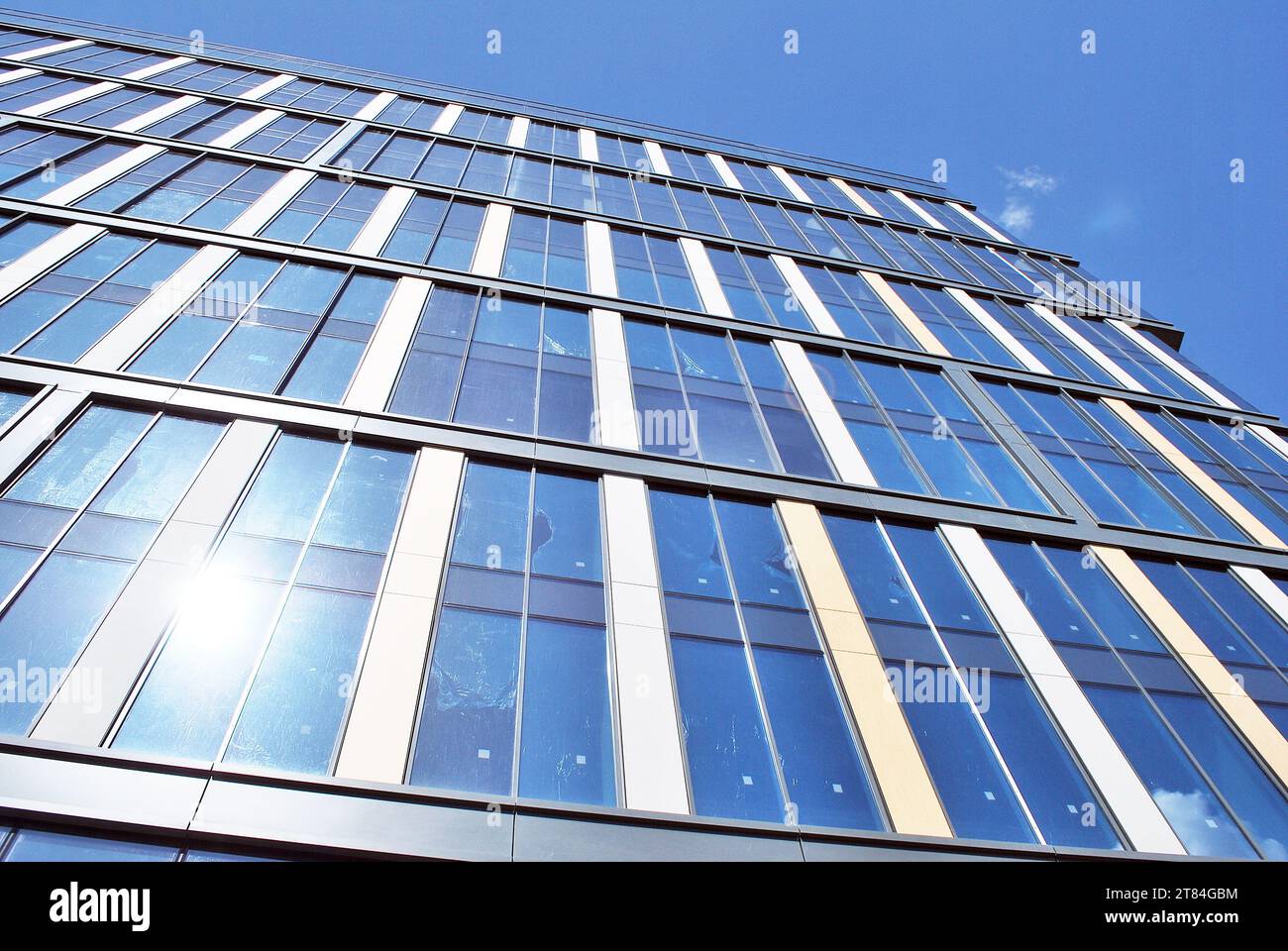 Abstract closeup of the glass-clad facade of a modern building covered ...