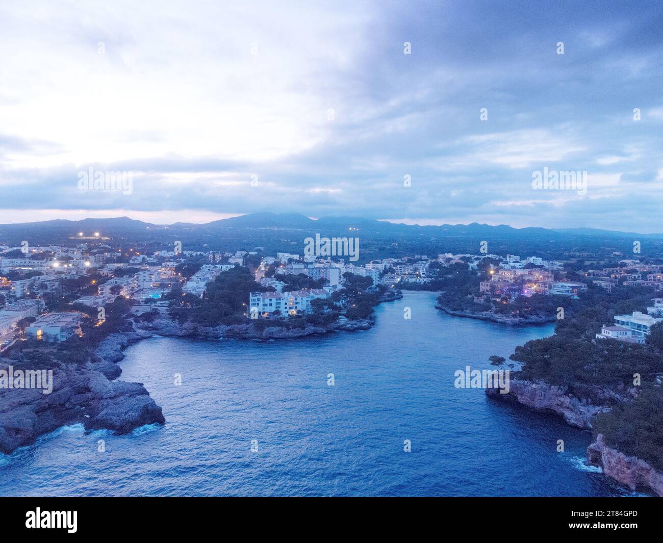 Aerial view of Cala Esmeralda at night , above the sea looking back at ...