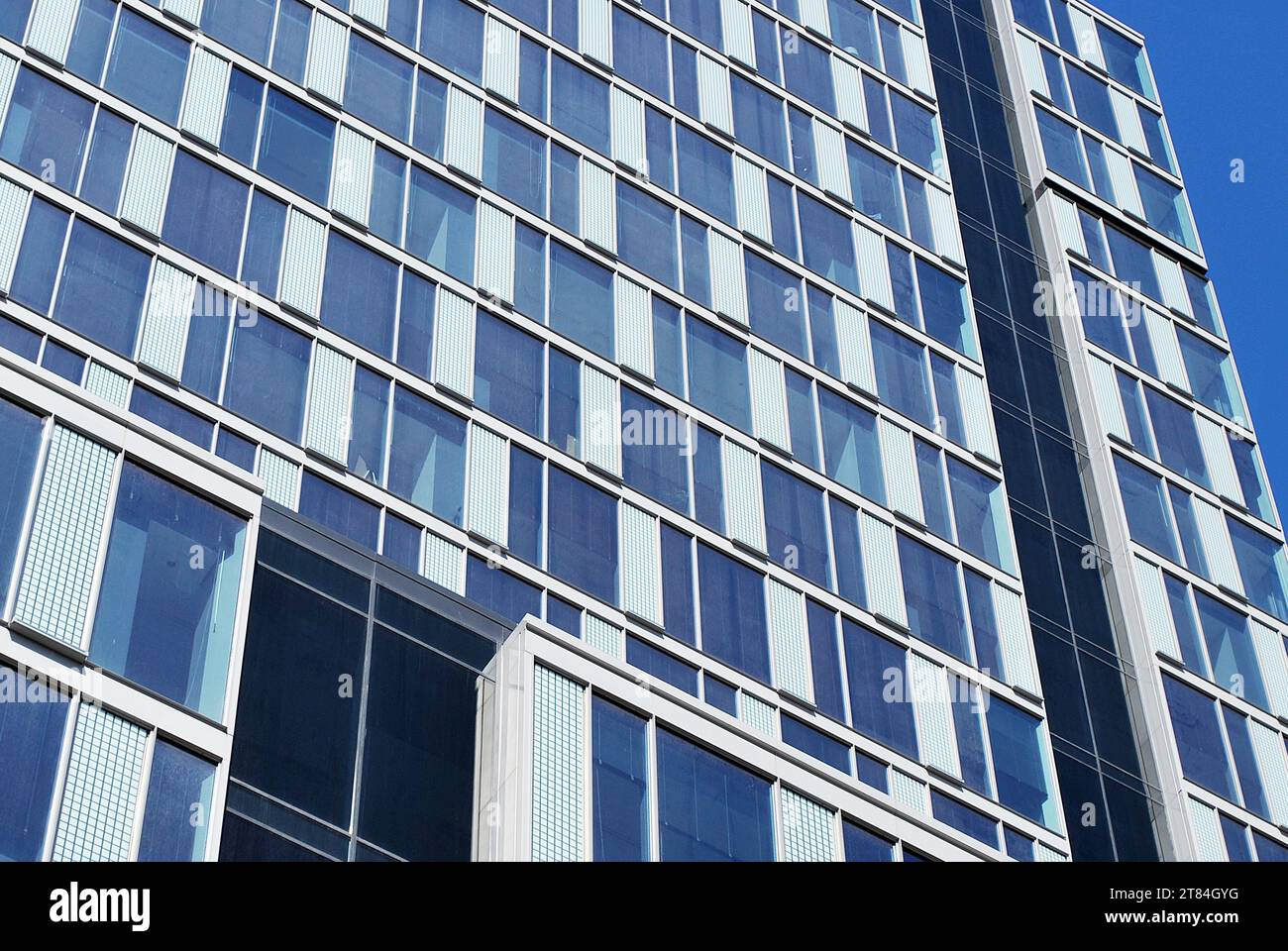 Abstract closeup of the glass-clad facade of a modern building covered ...