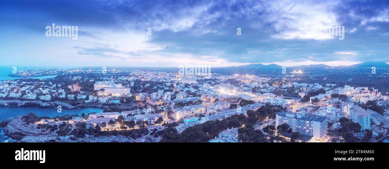 Aerial view of Cala Esmeralda at night , above the sea looking back at ...