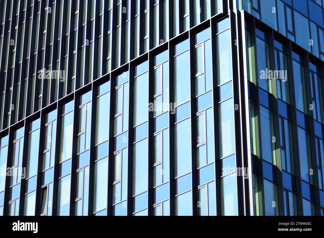 Abstract closeup of the glass-clad facade of a modern building covered ...