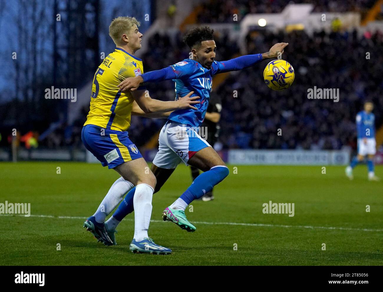 Colchester United's Zach Mitchell (left) and Stockport County's Odin ...