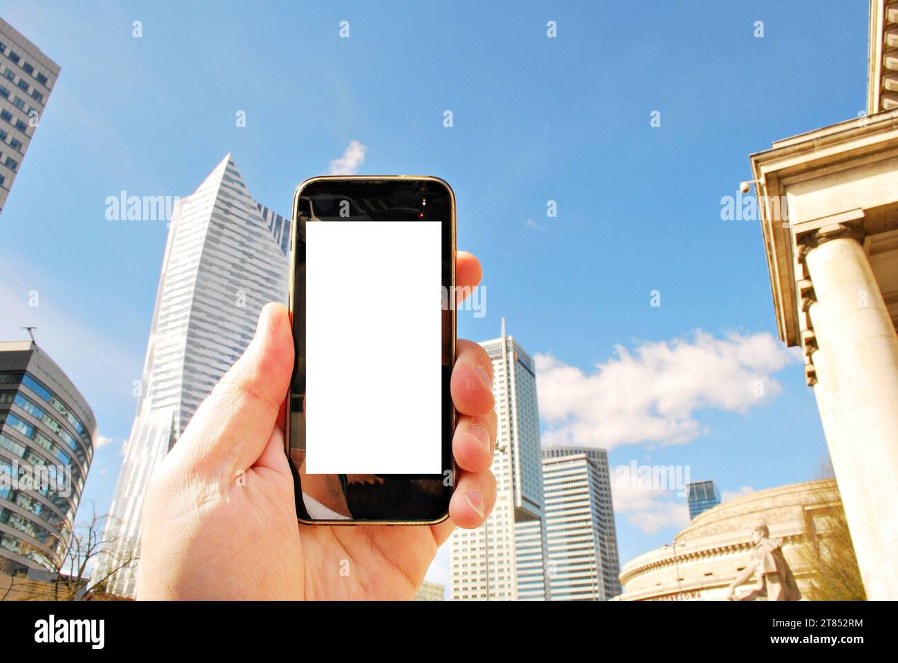 Hand holding smartphone. City in the background Stock Photo - Alamy