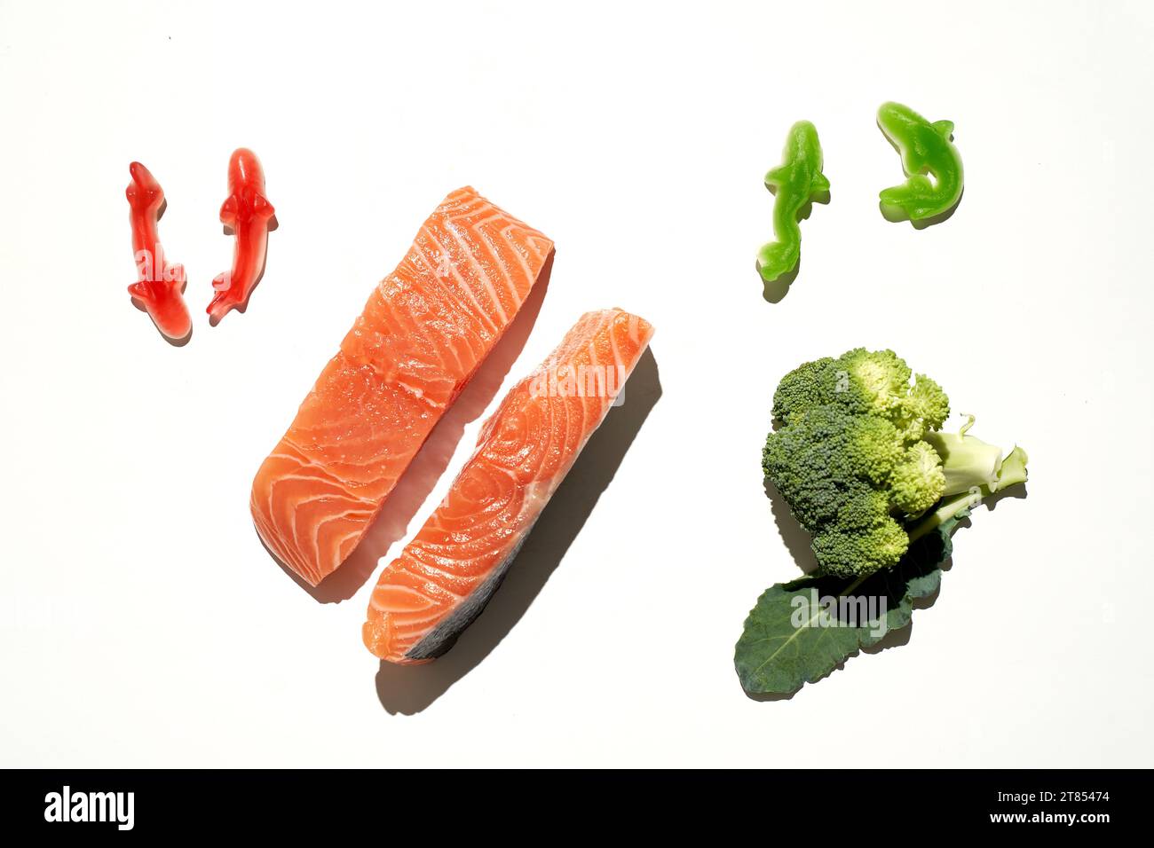 Gummy vitamins candy in shape of sharks and raw salmon fish and ...