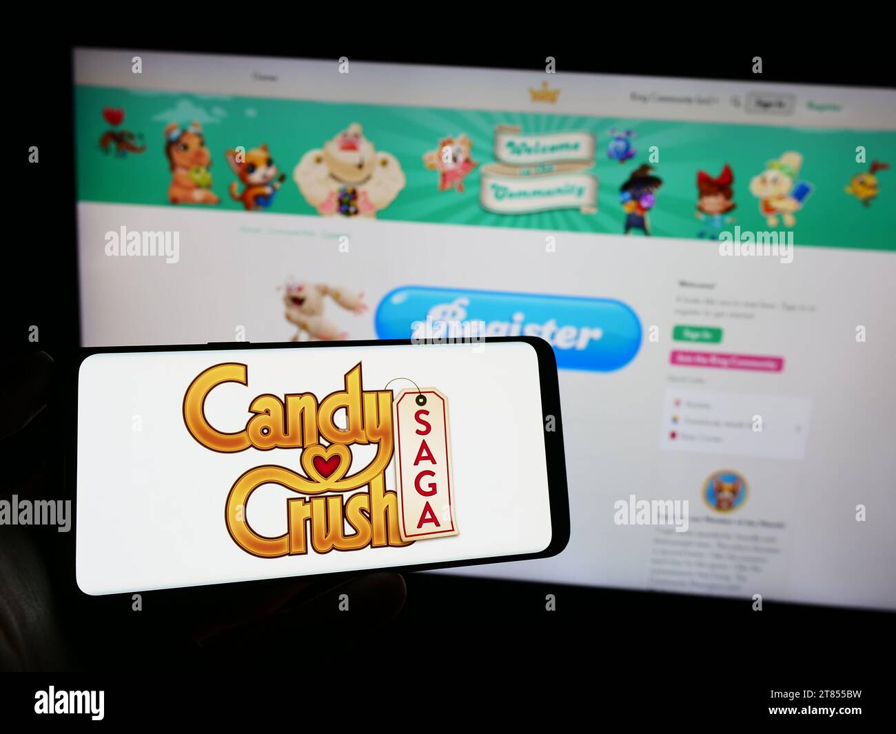 Person holding mobile phone with logo of tile-matching video game Candy ...