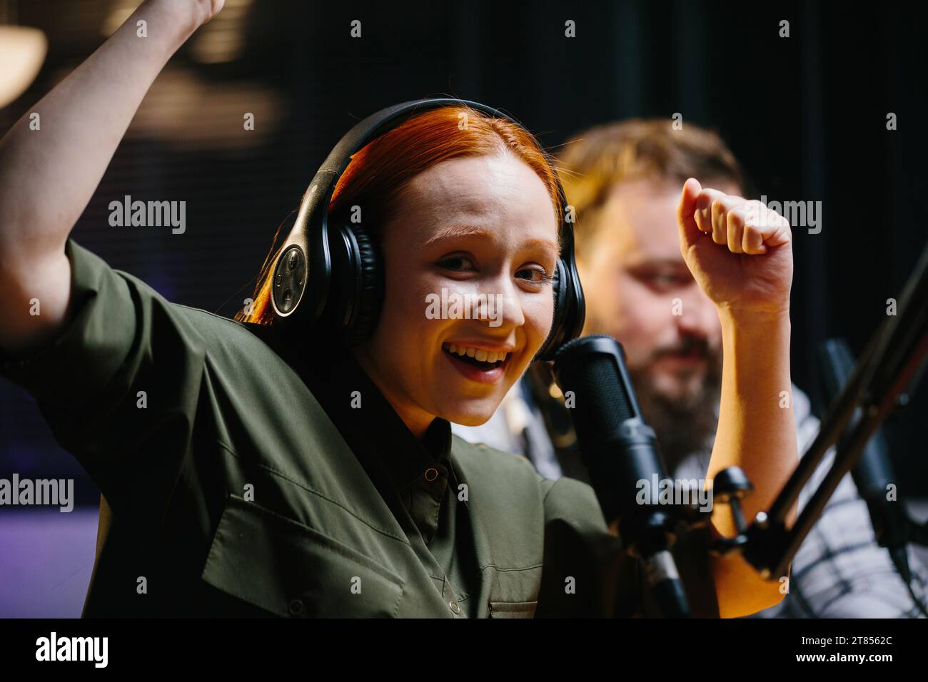 Cheerful positive radio host of the evening broadcast, posing for the ...