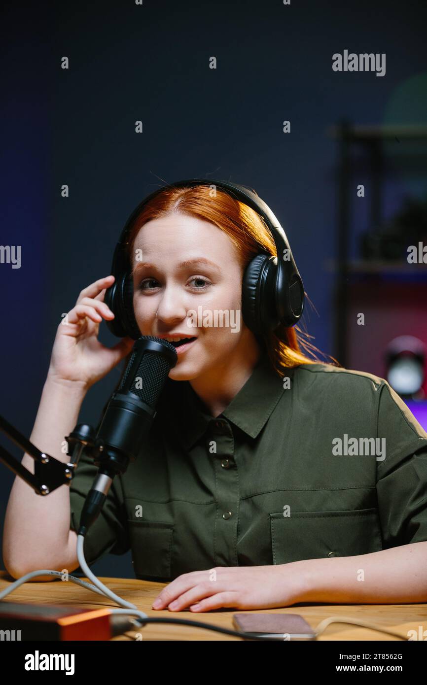 The girl presenter speaks into the microphone during the broadcast on ...
