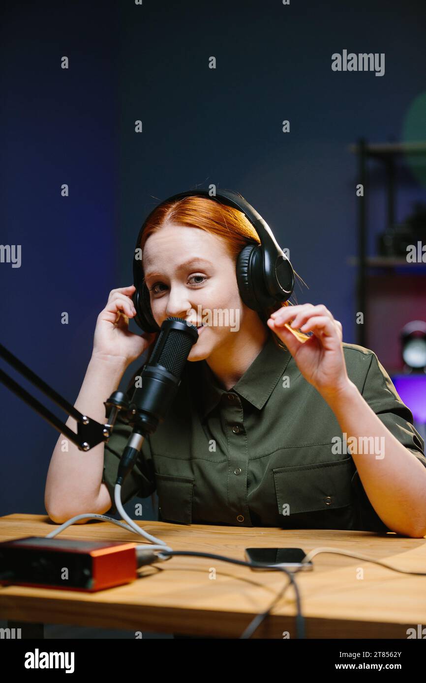 The girl presenter speaks into the microphone during the broadcast on ...