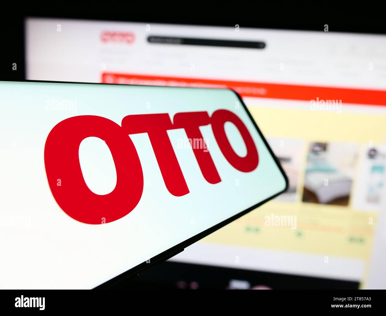 Mobile phone with logo of German mail order company Otto GmbH Co KG in front of business website ...