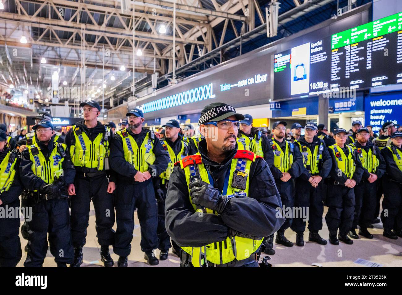 London, UK. 18th Nov, 2023. Police advance in a military formation and ...