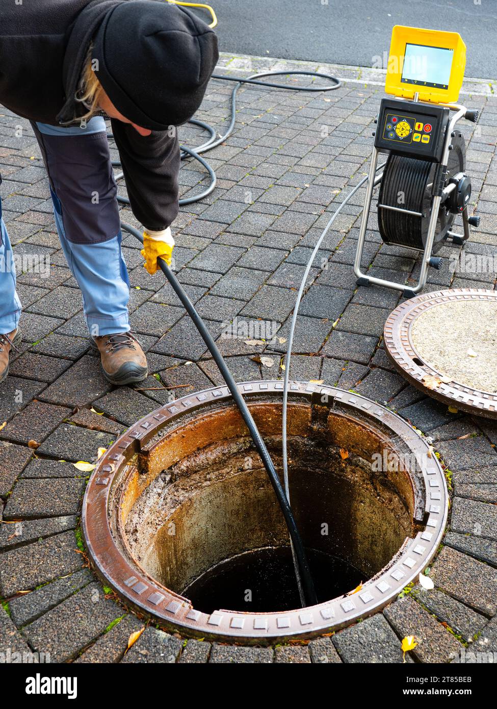 A drain cleaning company checks a blocked drain with a camera before ...