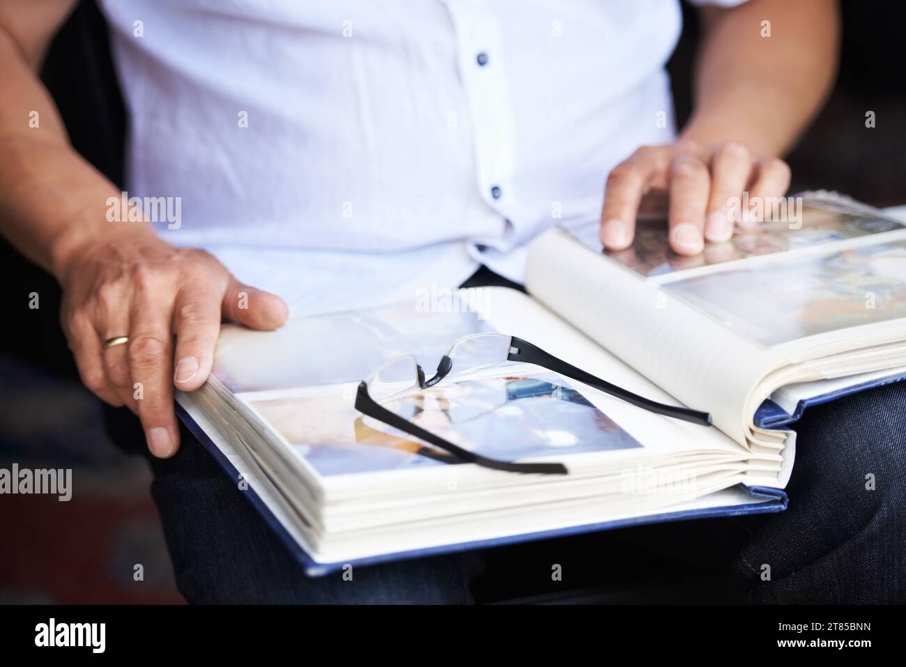 Photo album, photograph and hands of person for memory, reflection and ...