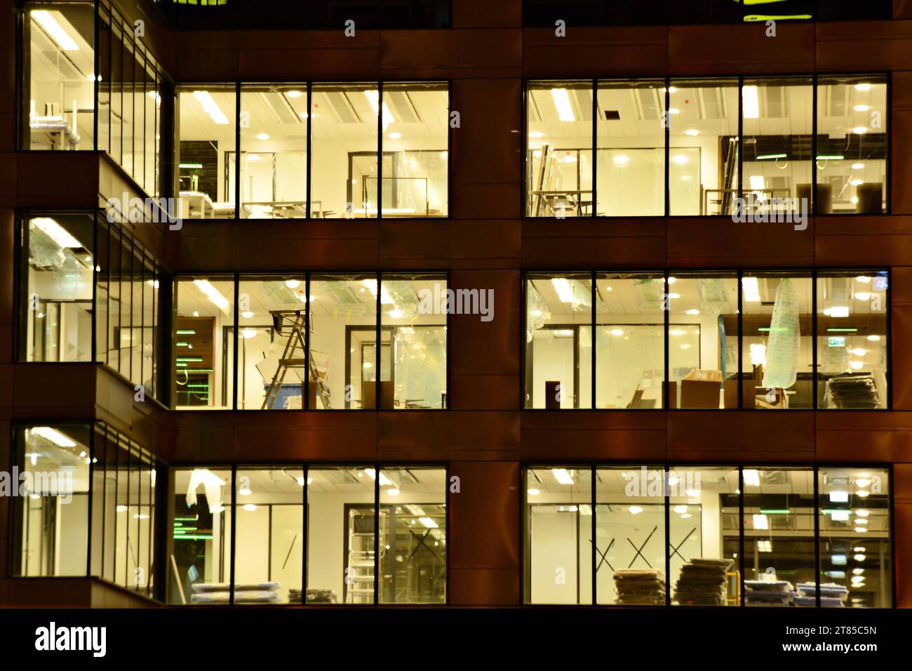 Pattern of office buildings windows illuminated at night. Glass ...