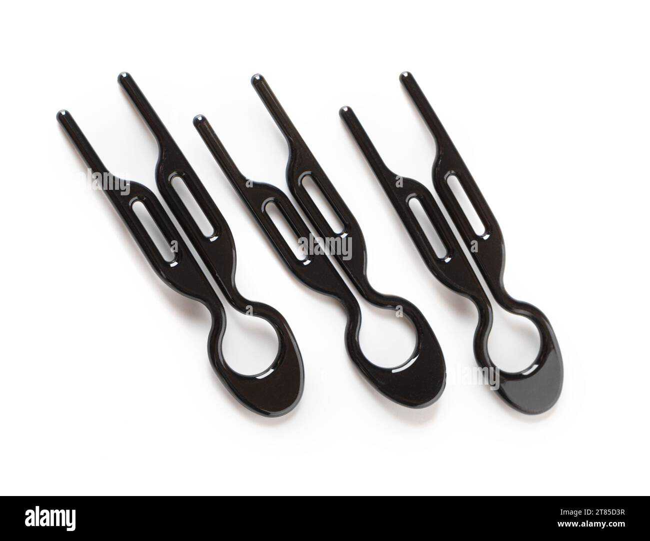 Black hair clips on isolated white background Stock Photo - Alamy