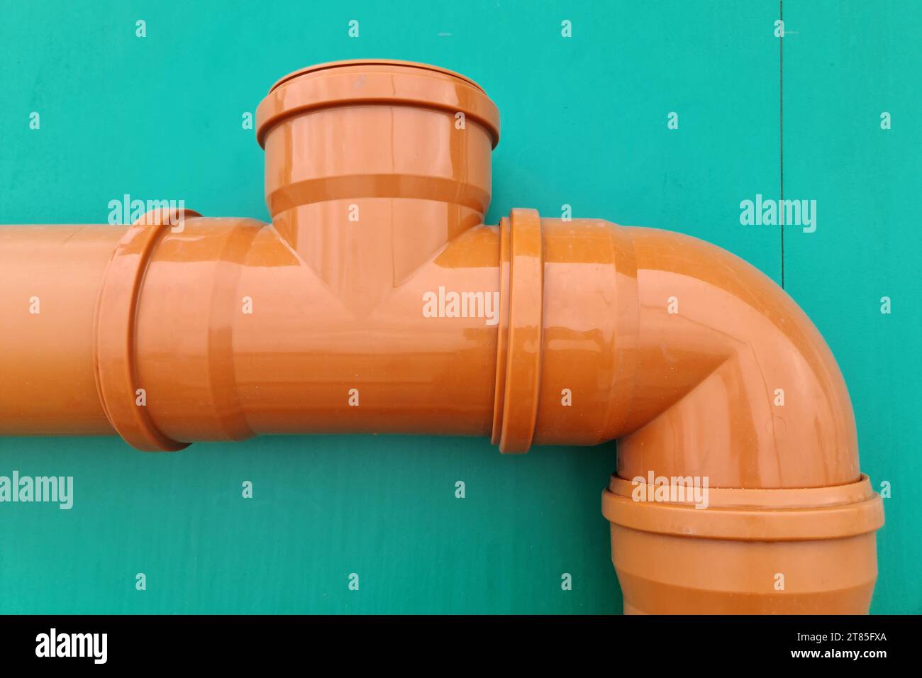 Connection from a tee and a 90 degree bend on an orange sewer pipe ...