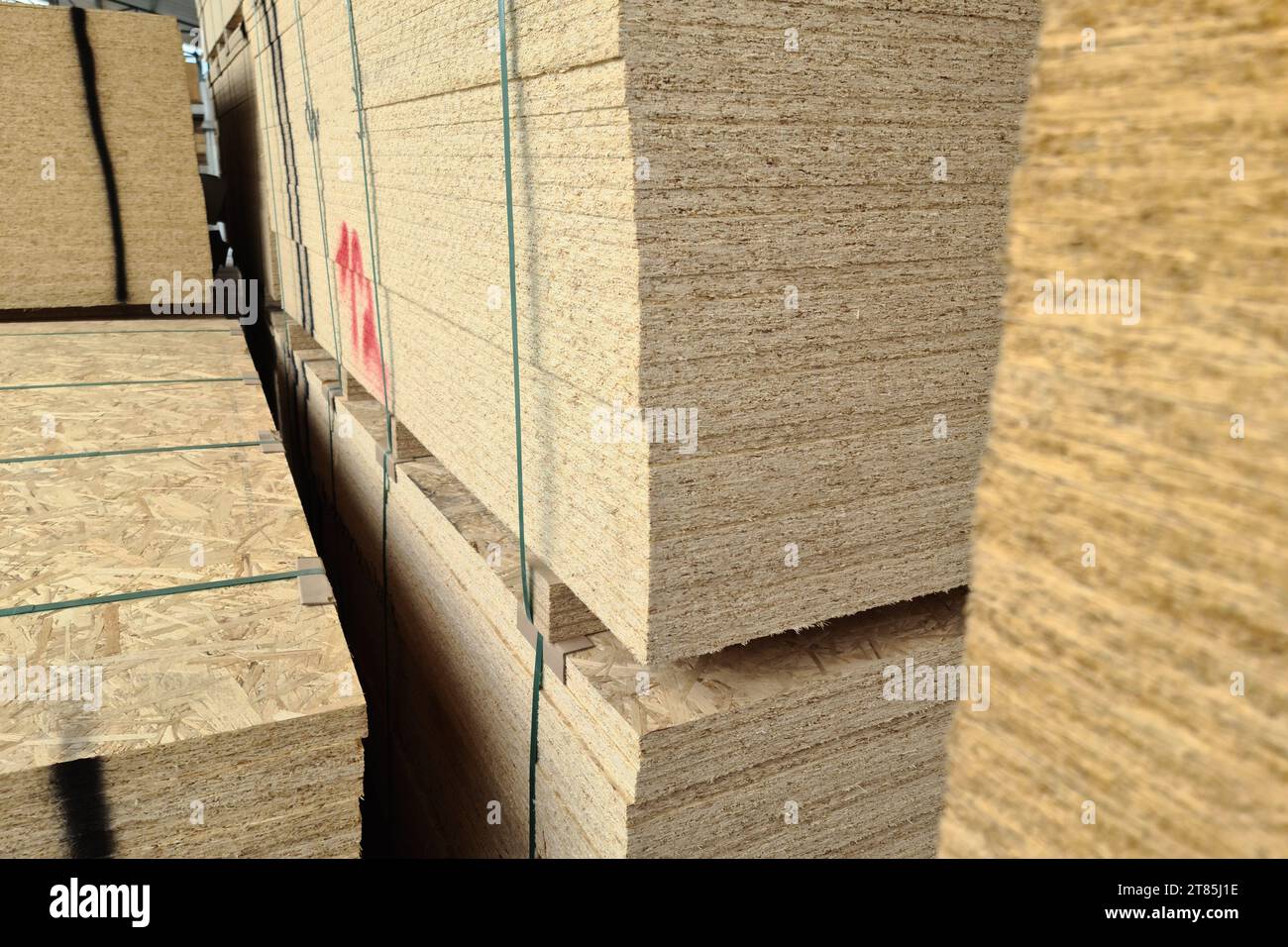 OSB sheets lie in stacks in a warehouse for sale. Hardware store Stock ...