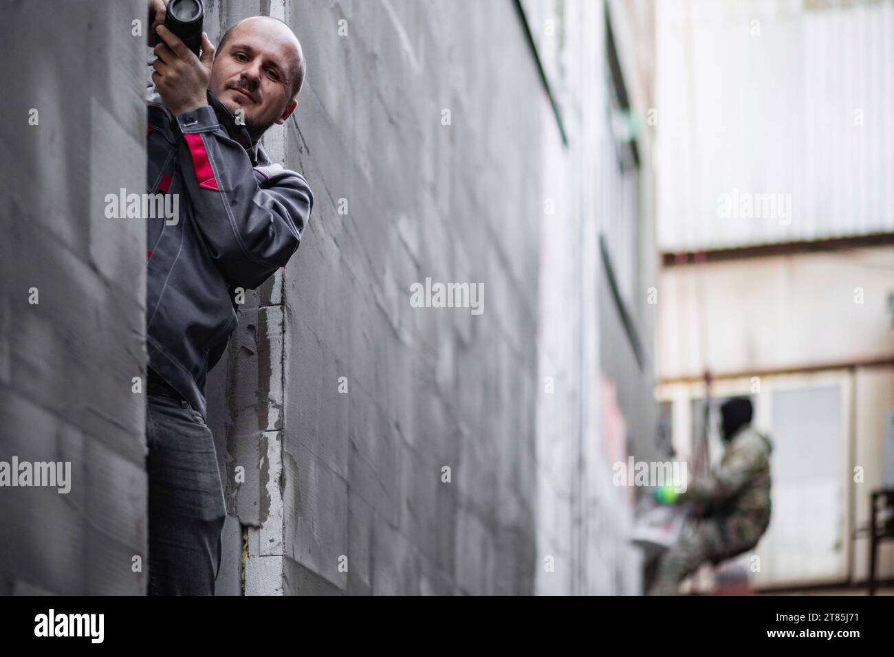 Professional industrial photographer supervises, records construction ...