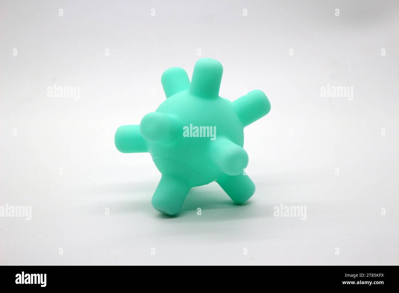 Small green rubber ball toy on a white background Stock Photo - Alamy