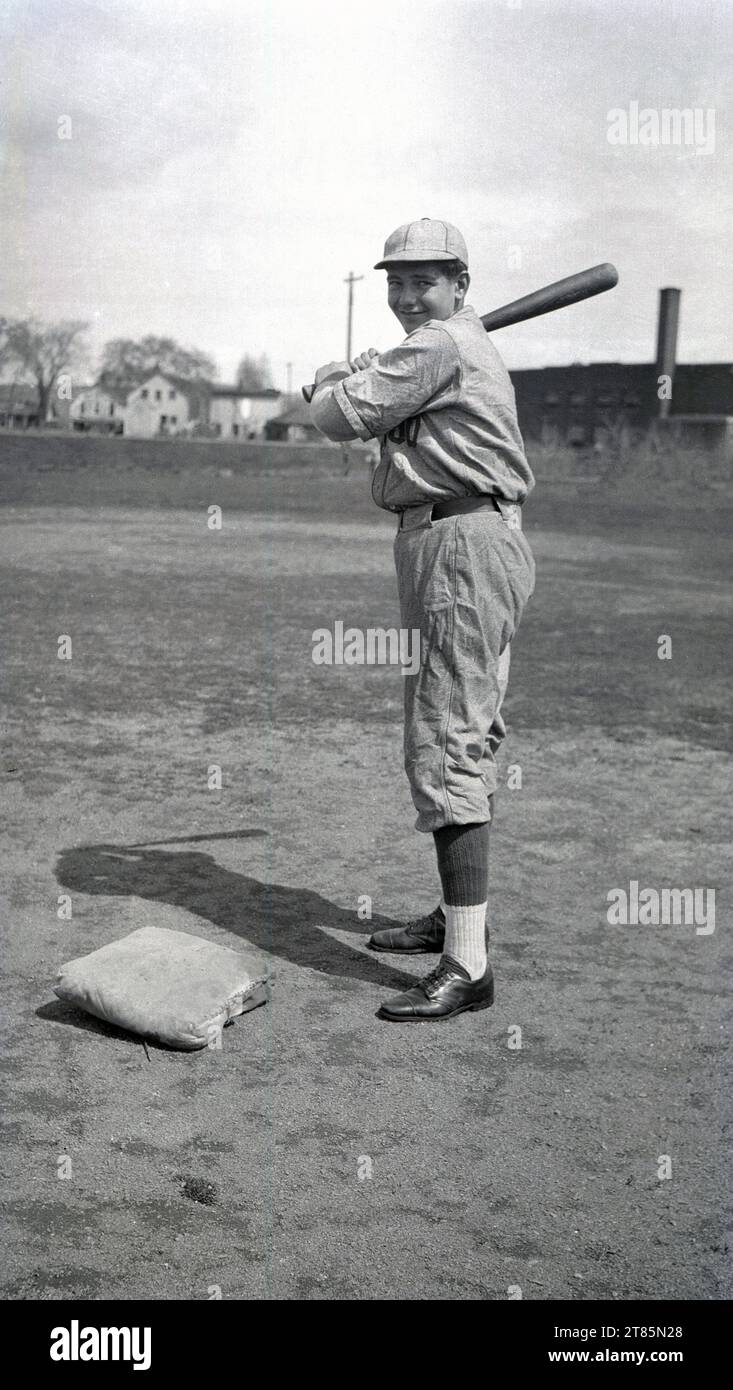 1930s, historical, a teenage boy wearing a baseball outfit, standing ...