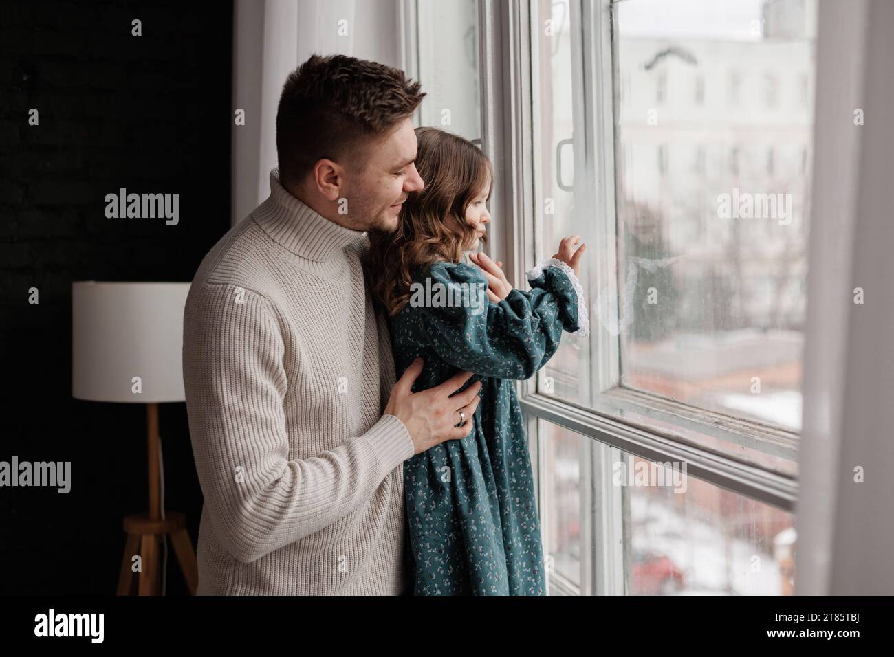 Fathers day. Happy loving young dad embracing adorable little daughter ...