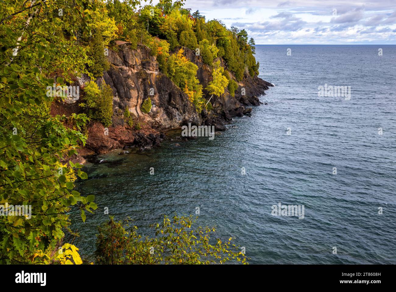Hiking trail on the Presque Isle peninsula with a view of Lake Superior ...