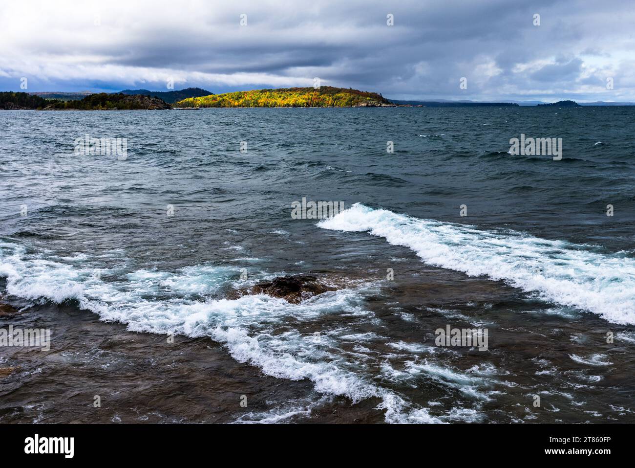 Hiking trail on the Presque Isle peninsula with a view of Lake Superior ...