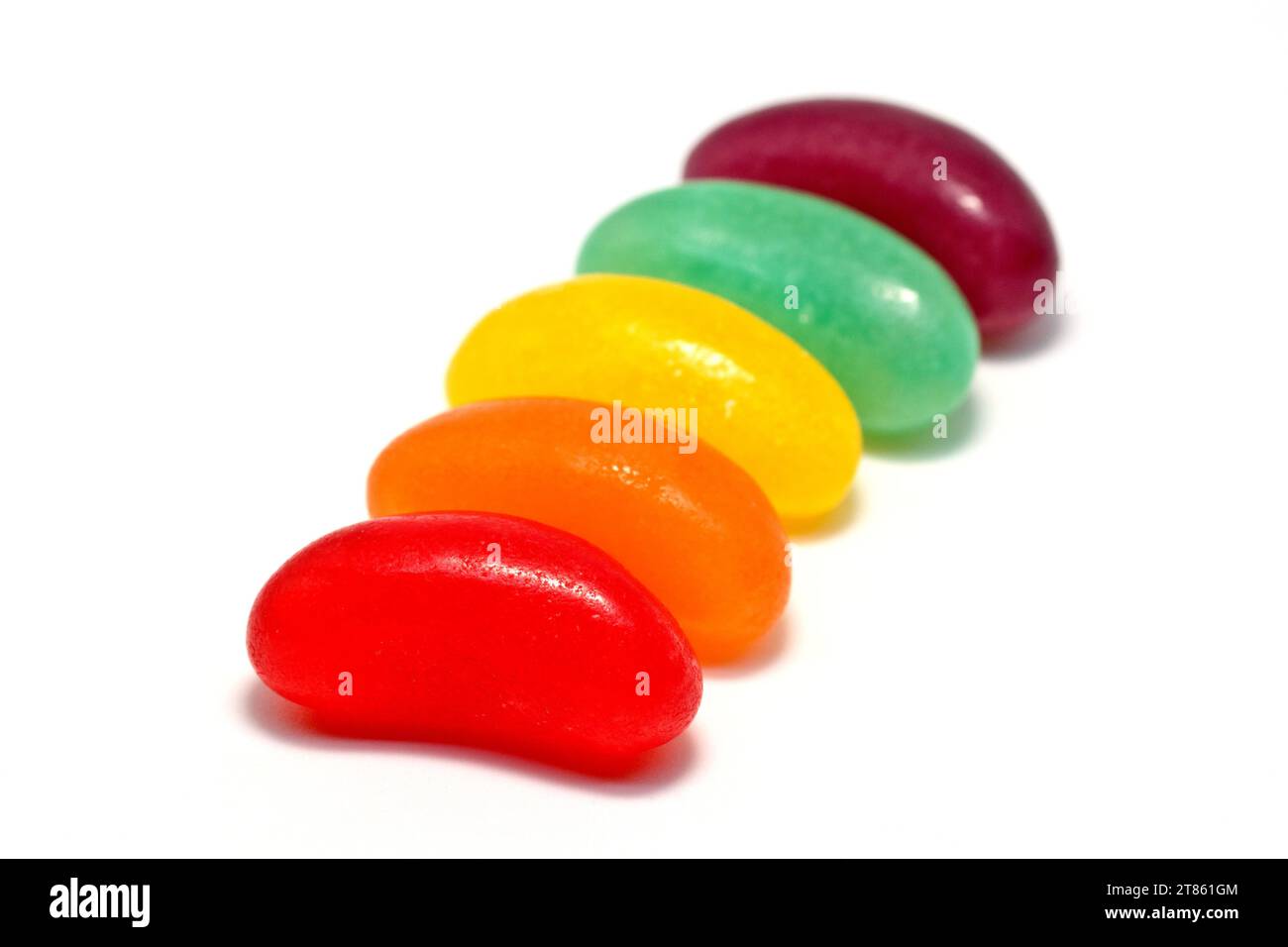 Close up of a row of colourful jelly beans in a rainbow pattern of red ...