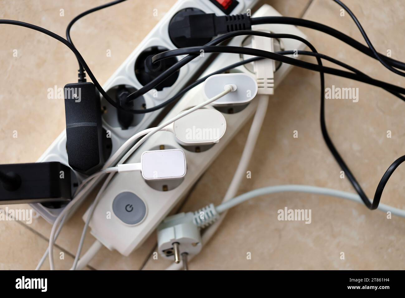 Overloaded power boards. Power strips with different electrical plugs ...
