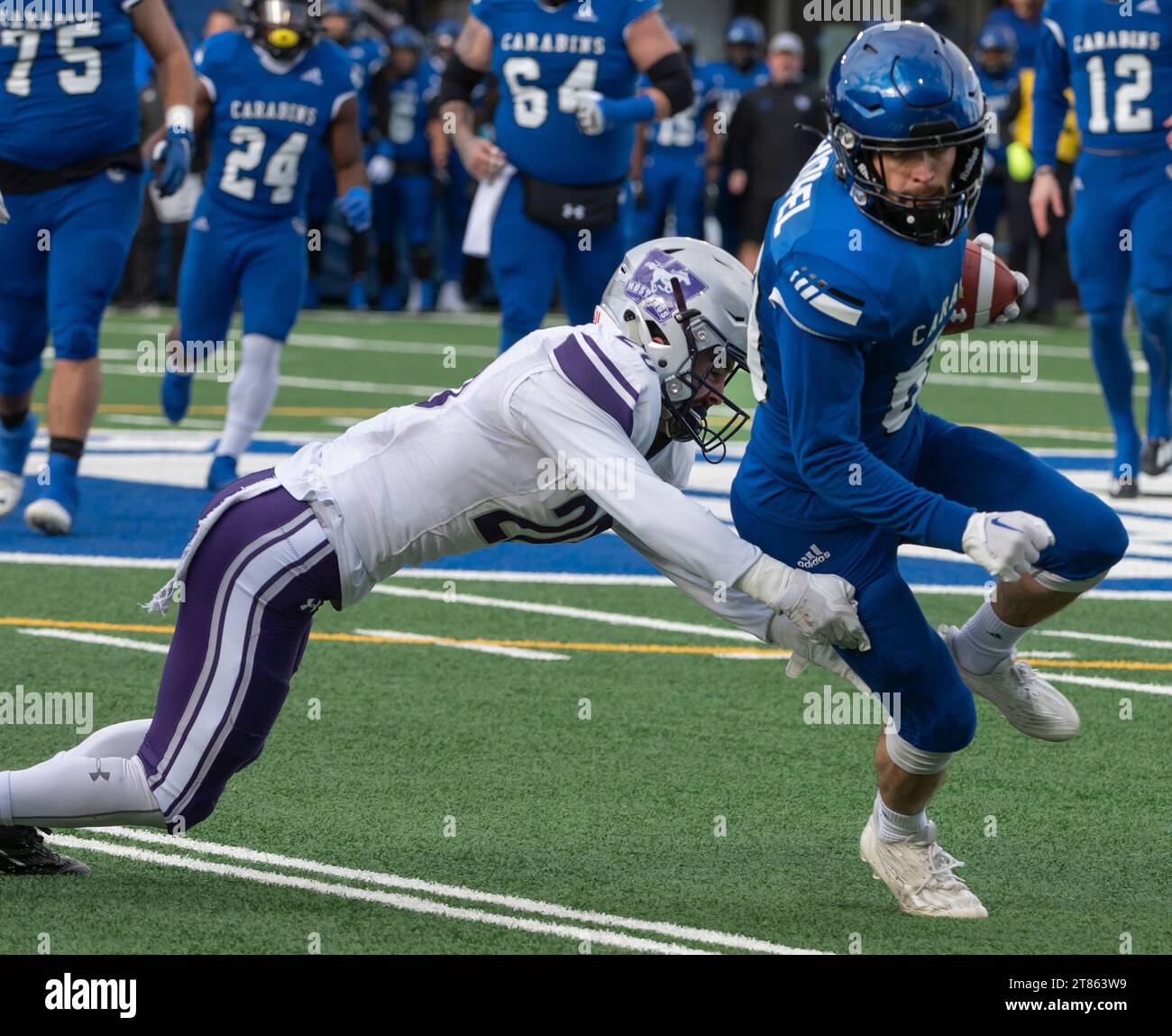 Montreal, Canada. 18th Nov, 2023. Western Mustangs Jacob Saunders (20) tries to tackle Montreal ...