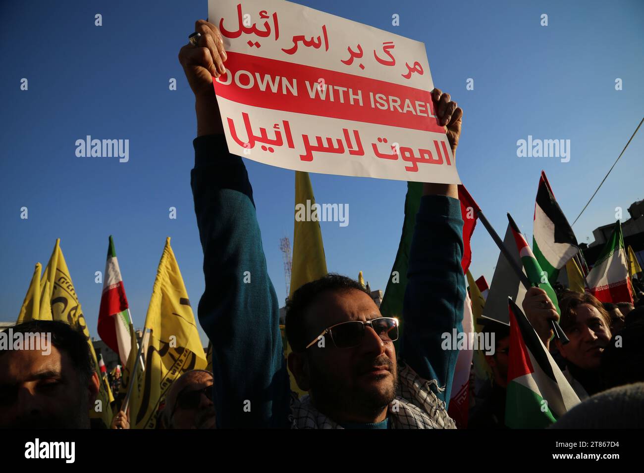 Tehran, Iran. 18th Nov, 2023. An Iranian man holds a banner written ...