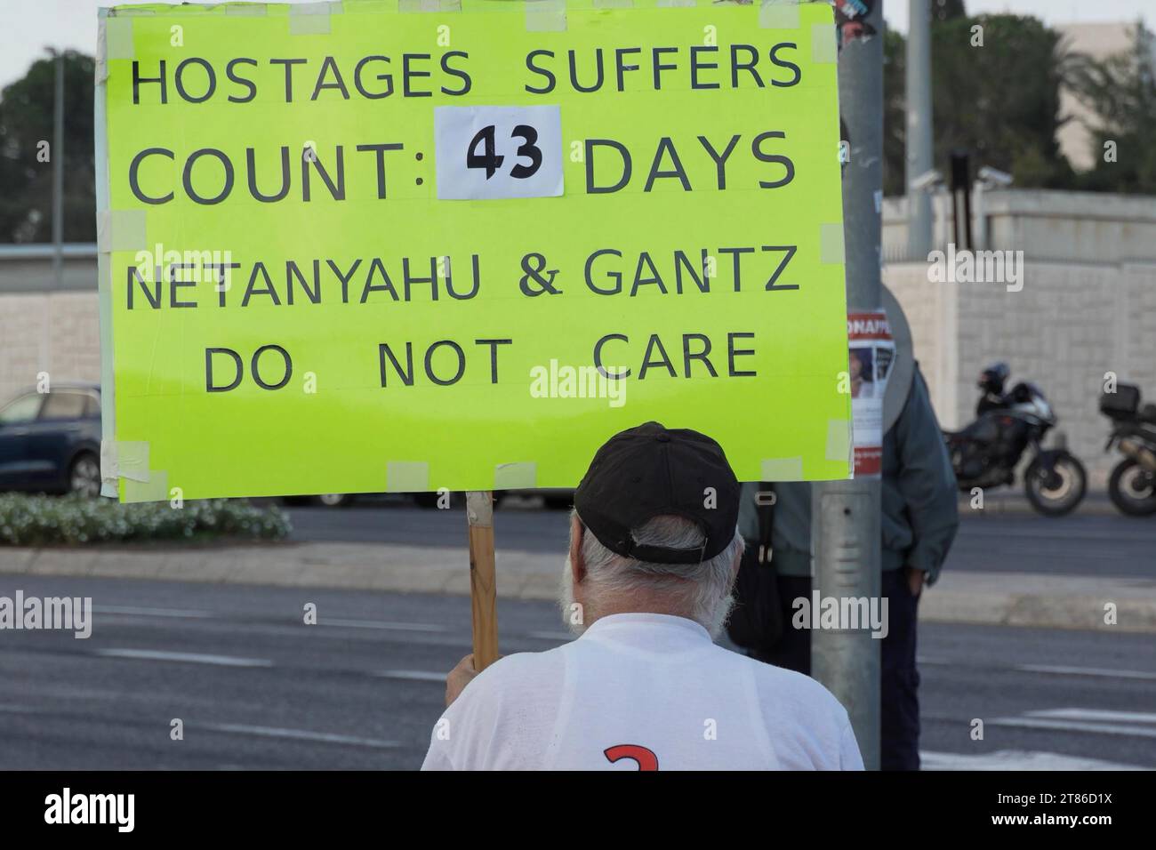 An Israeli man holds a sign that reads "Hostages suffers count 43 days ...