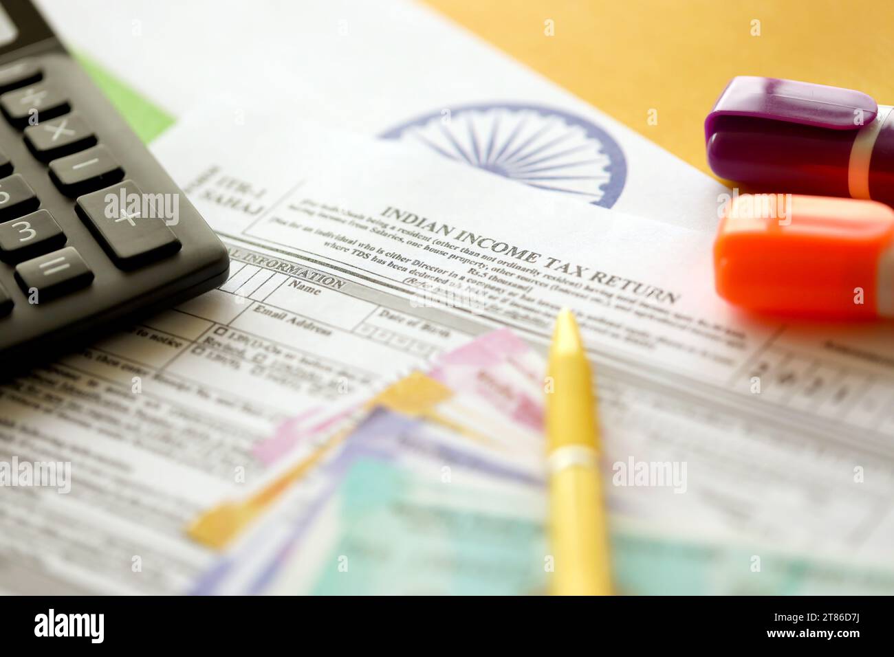Indian income tax return blank form with pen and indian rupees bills on ...