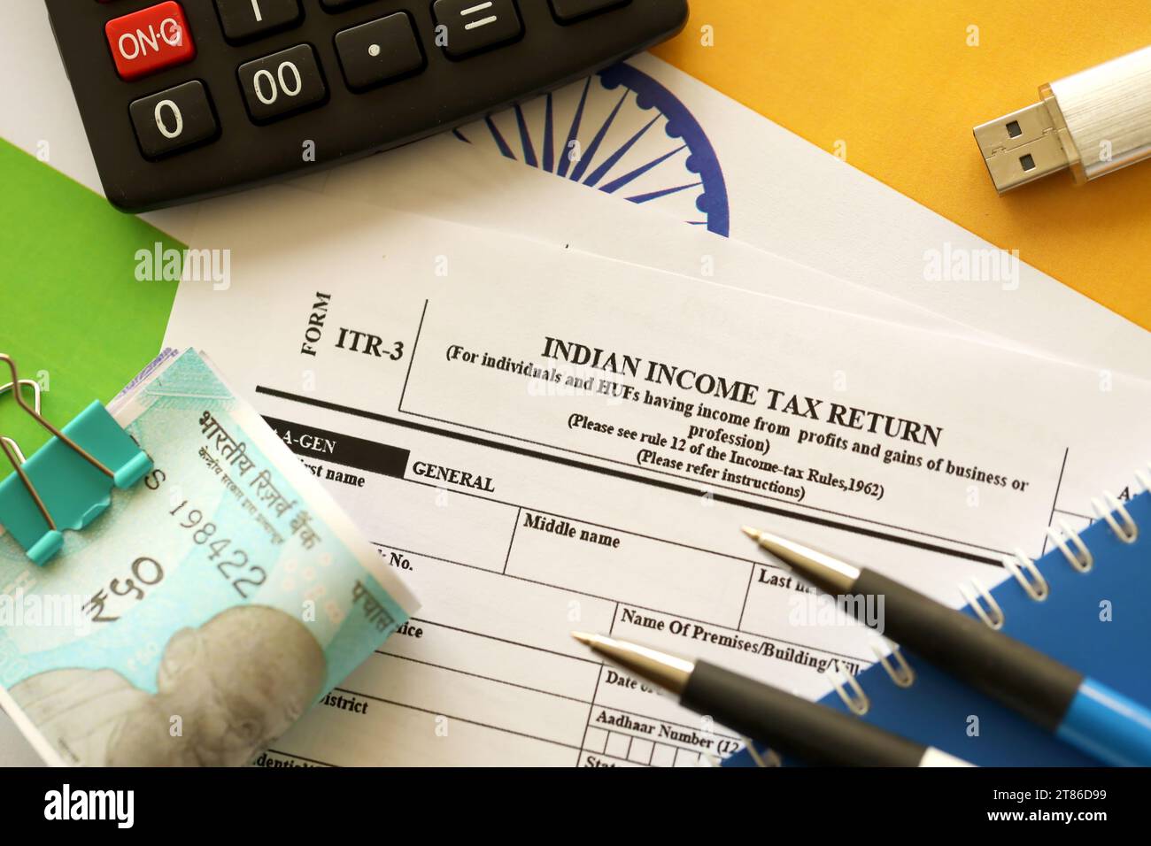 Indian income tax return blank form with pen and indian rupees bills on ...