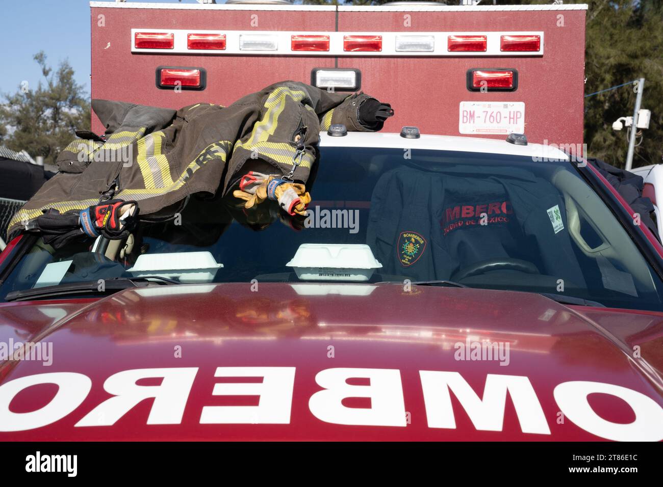 Firefighters use their kit to create shade to protect them from the ...