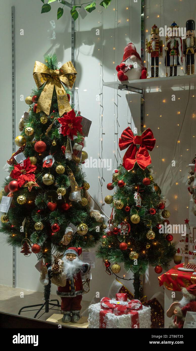 Close-up of Christmas items displayed in a shop window at night ...