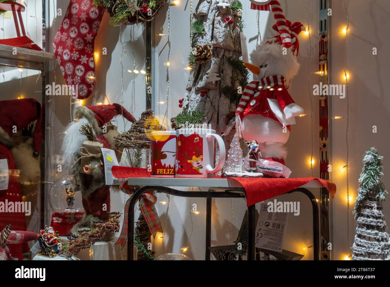 Close-up of Christmas items displayed in a shop window at night ...