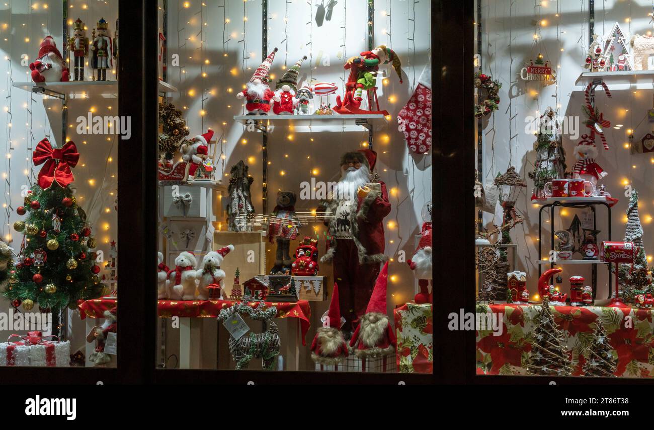 Close-up of Christmas items displayed in a shop window at night ...