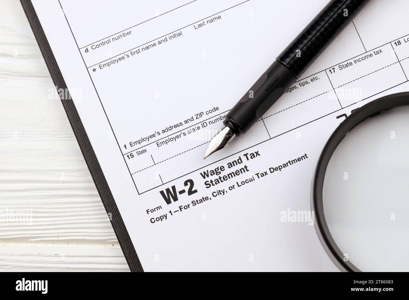 IRS Form W-2 Wage and Tax Statement blank on A4 tablet lies on office ...