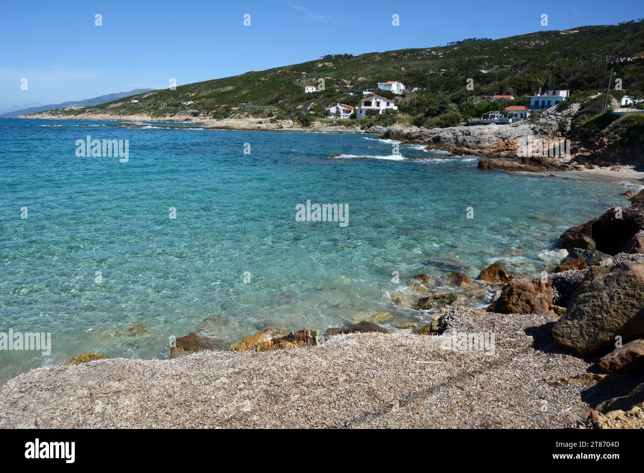 Crystal clear blue water at a rocky beach in Gialiskari on the north ...