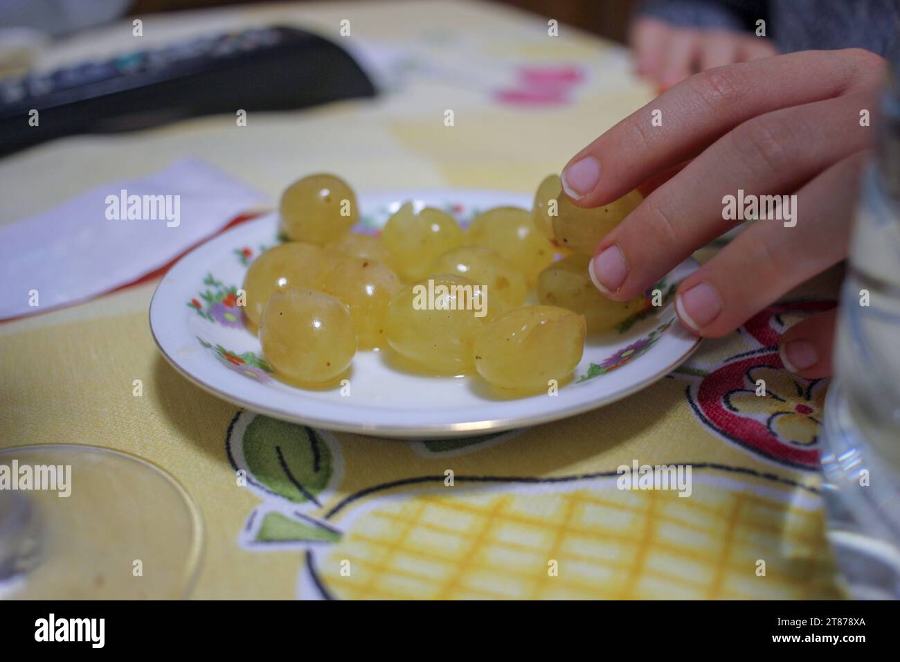 young boy taking the grapes of good luck in the first seconds of a New ...