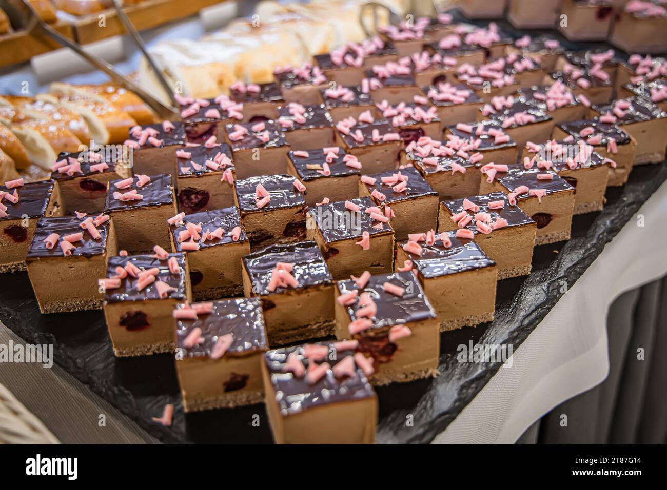 catering buffet food indoor. Different types of cakes on a buffet table ...