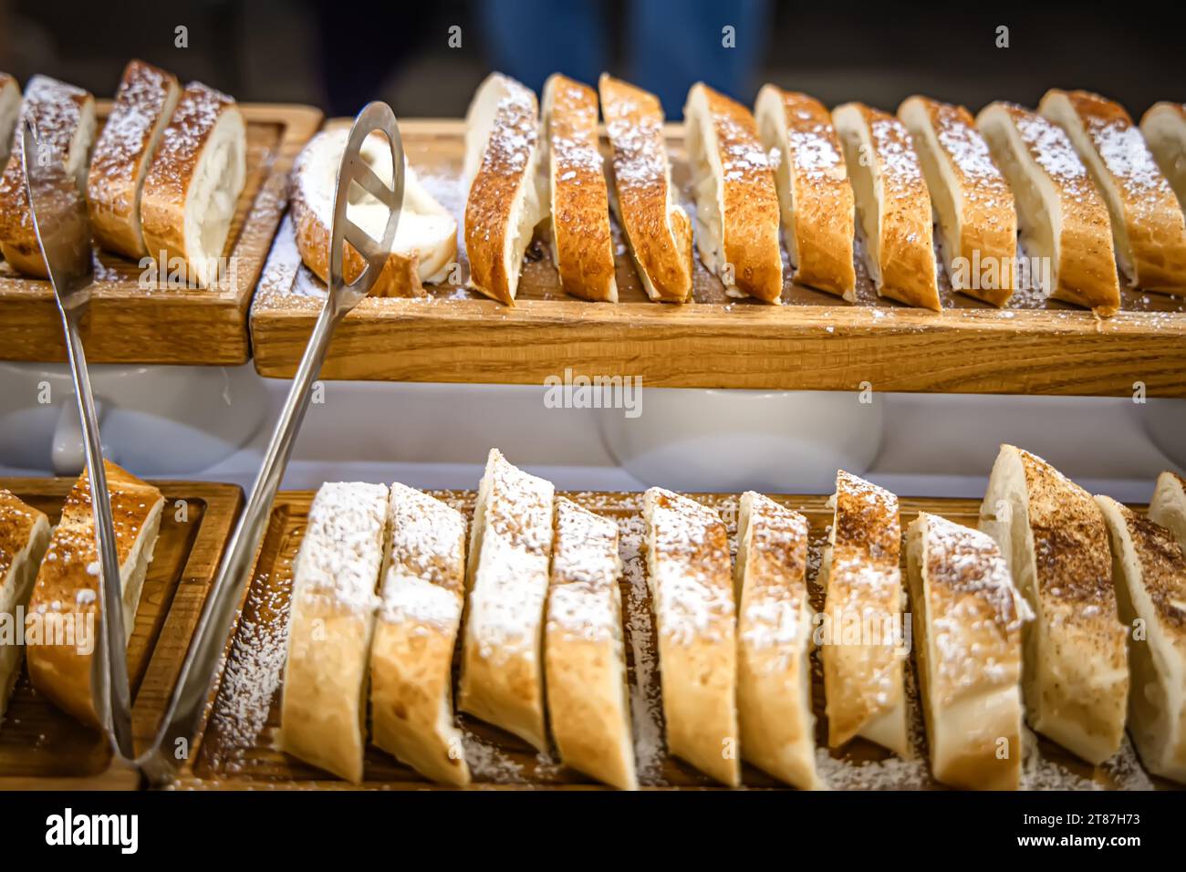 catering buffet food indoor. Slices of apple strudel on display in a ...