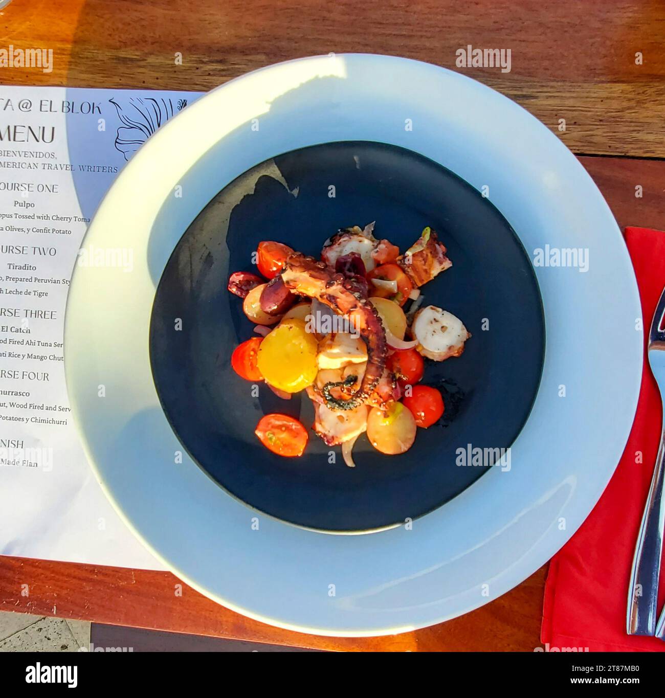 Wood fired octopus over vegetables Stock Photo - Alamy